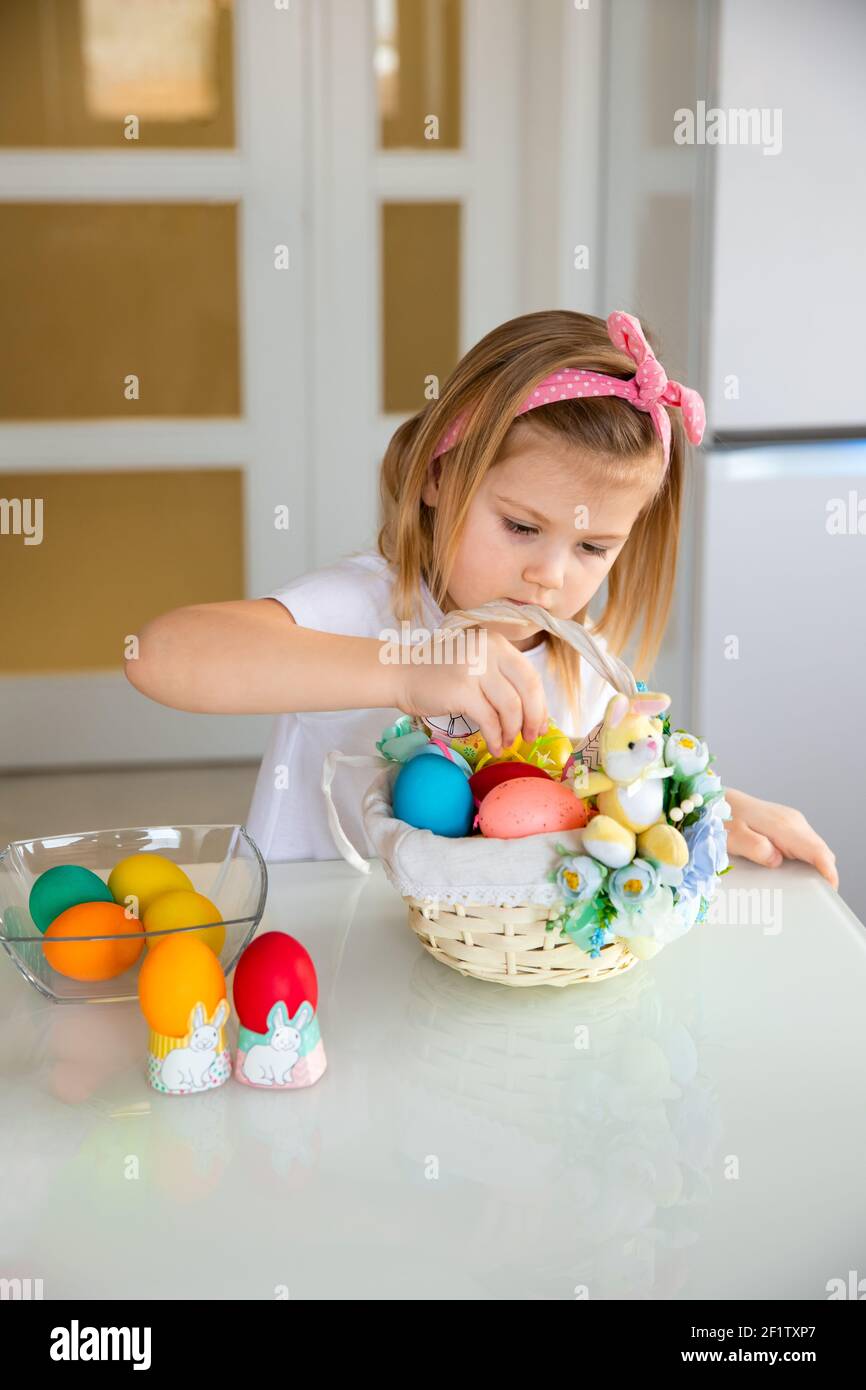 Little girl decorate easter basket Stock Photo - Alamy
