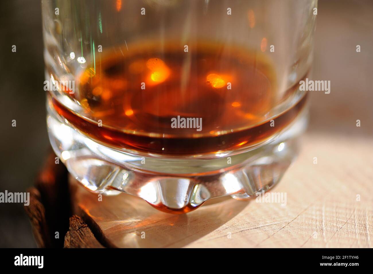 Almost empty glass of coffee on wooden board closeup Stock Photo - Alamy