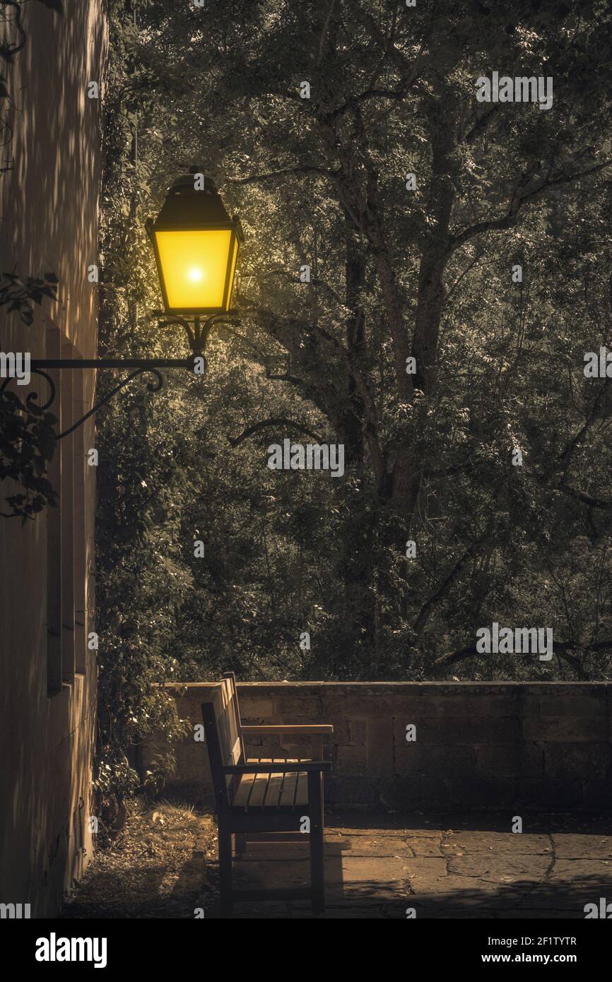 Lonely bench under a lamp by night Stock Photo - Alamy
