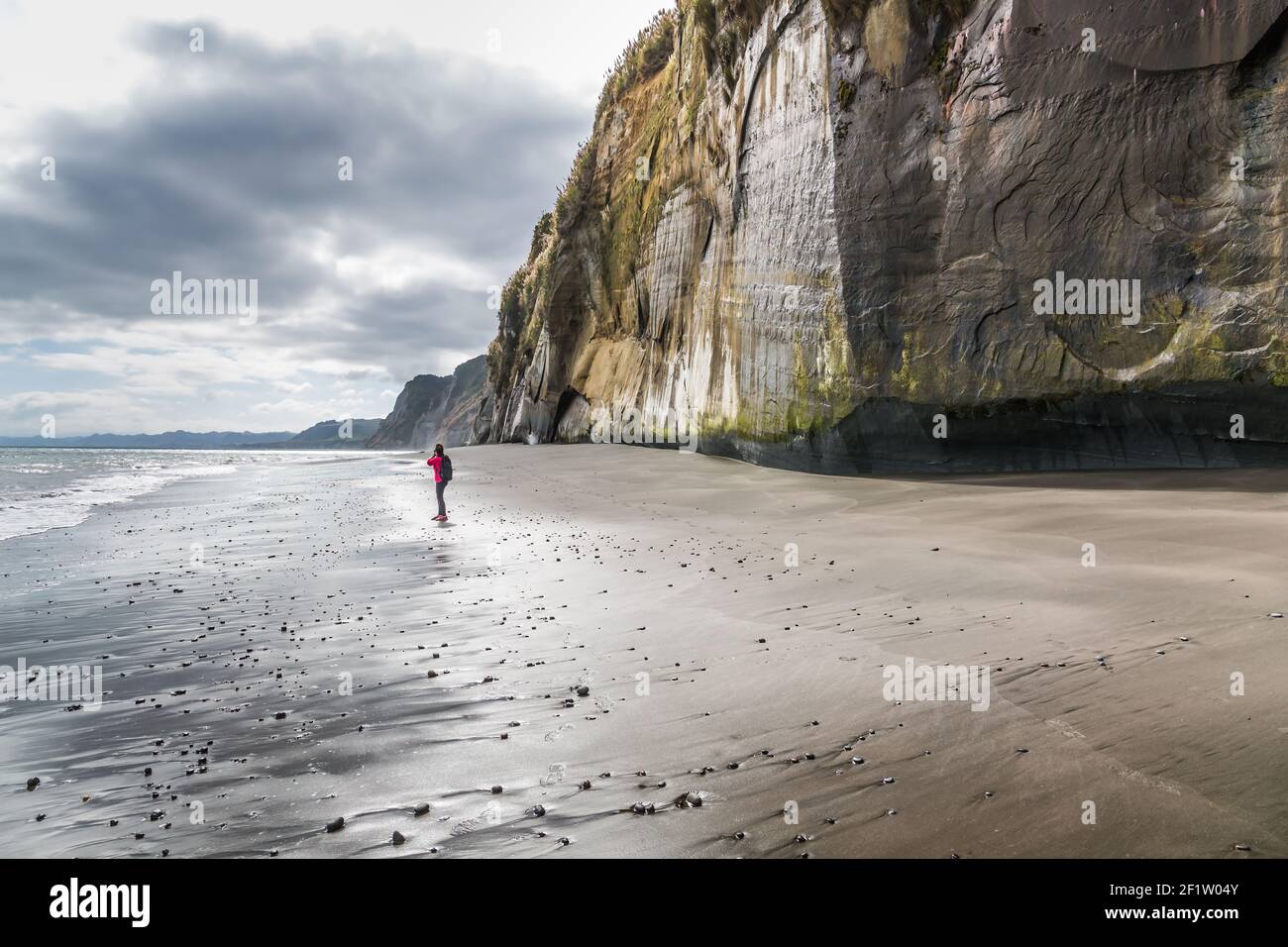 Woman on lonely beach hi-res stock photography and images - Alamy