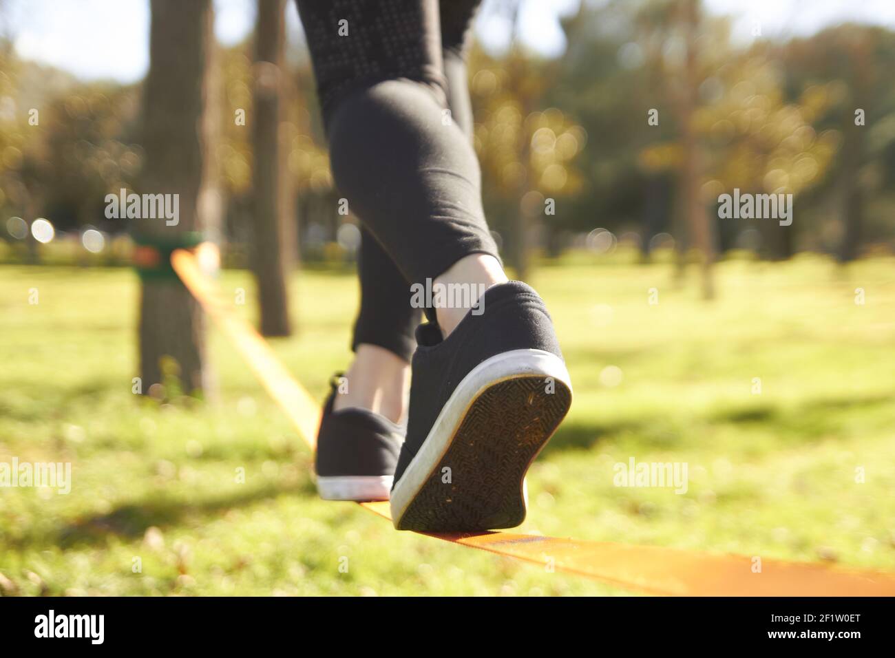 Female feet walking a slackline in the park Stock Photo - Alamy