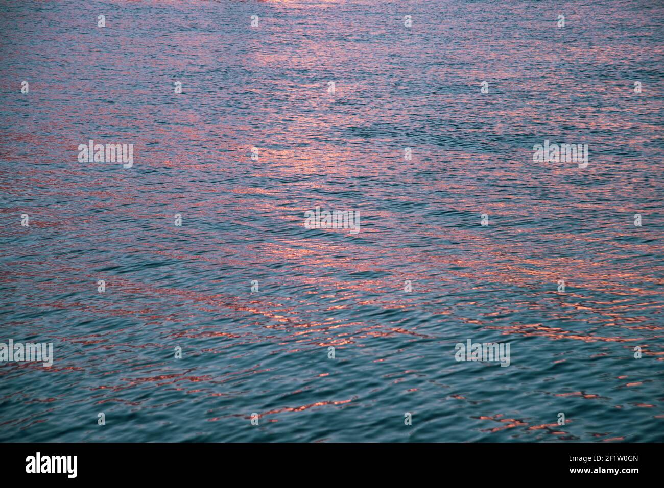Sea texture on sunset with red and blue colors Stock Photo - Alamy