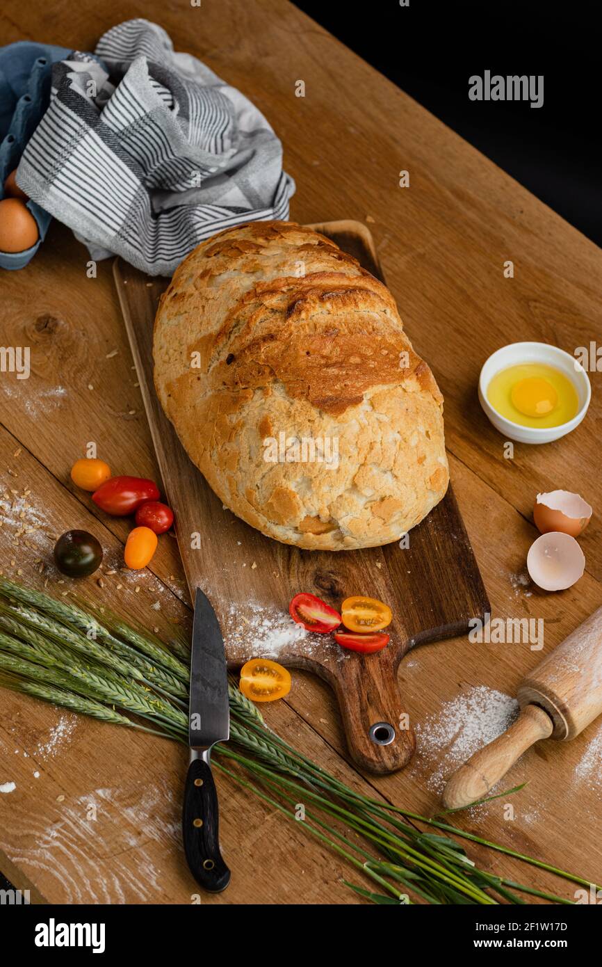 A vertical shot of a crusty bread loaf on a rustic background Stock ...
