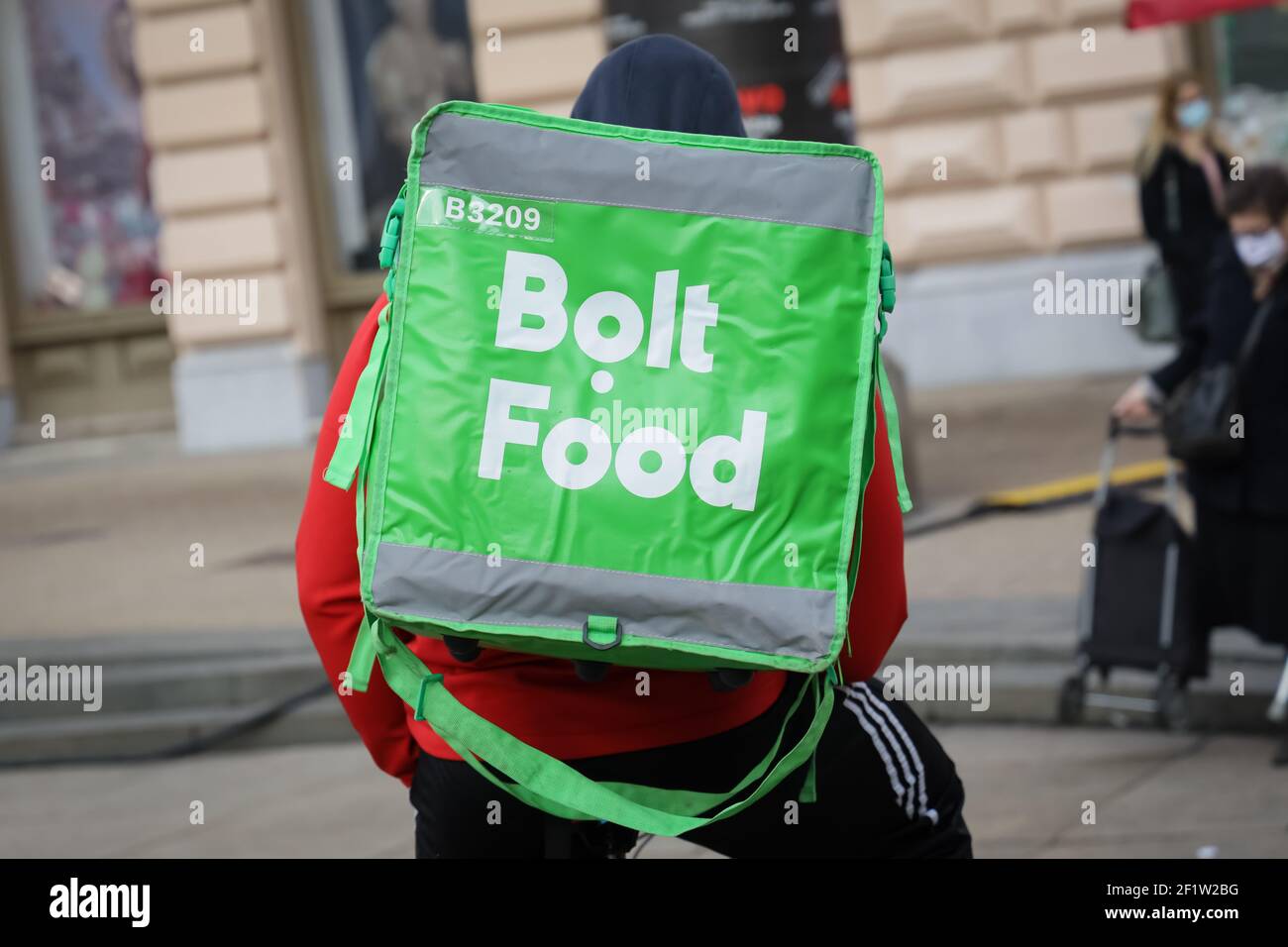 A Bolt Food delivery man on a bicycle is waiting for an order to ...