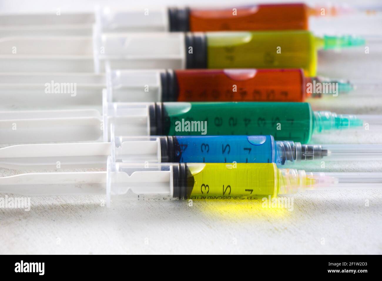 A closeup of different colorful chemicals in syringe needles on the ...