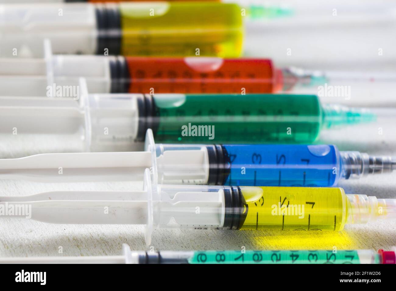 A closeup of different colorful chemicals in syringe needles on the ...