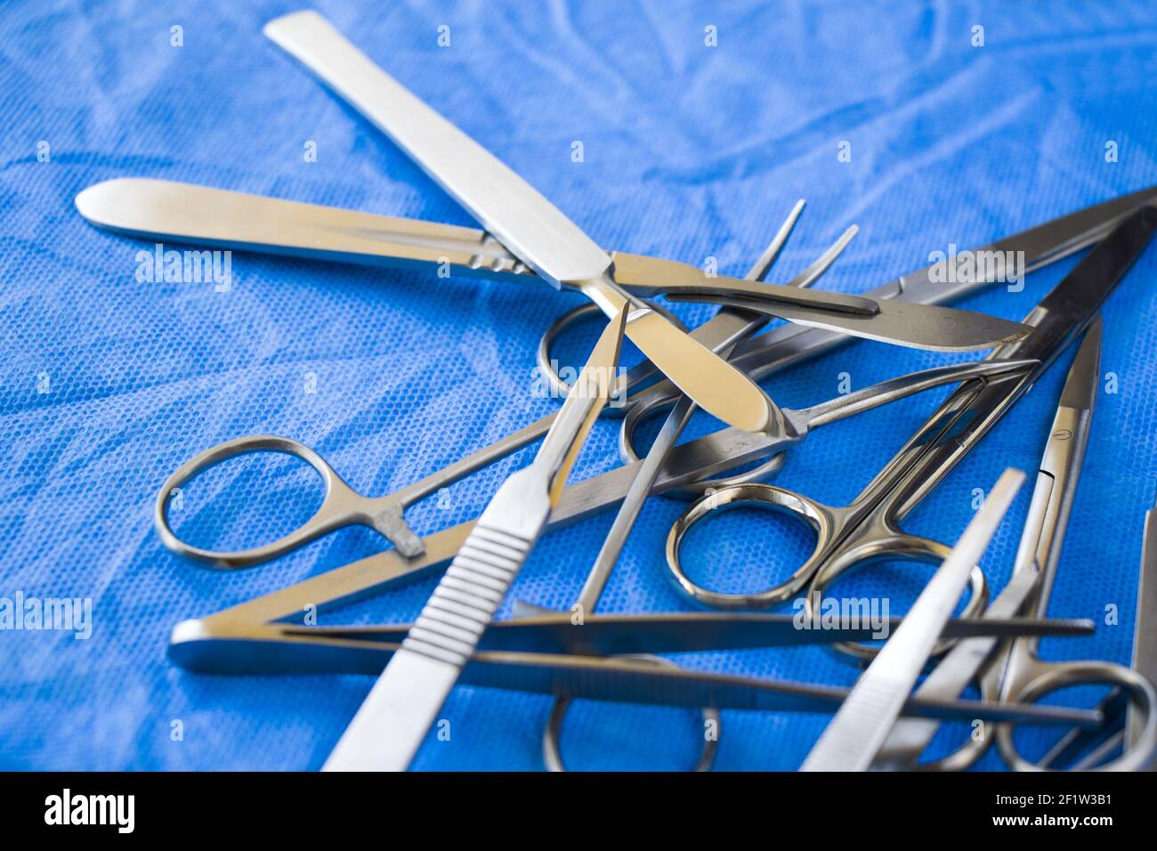 A closeup of a dissection kit on a blue surface in the hospital Stock ...