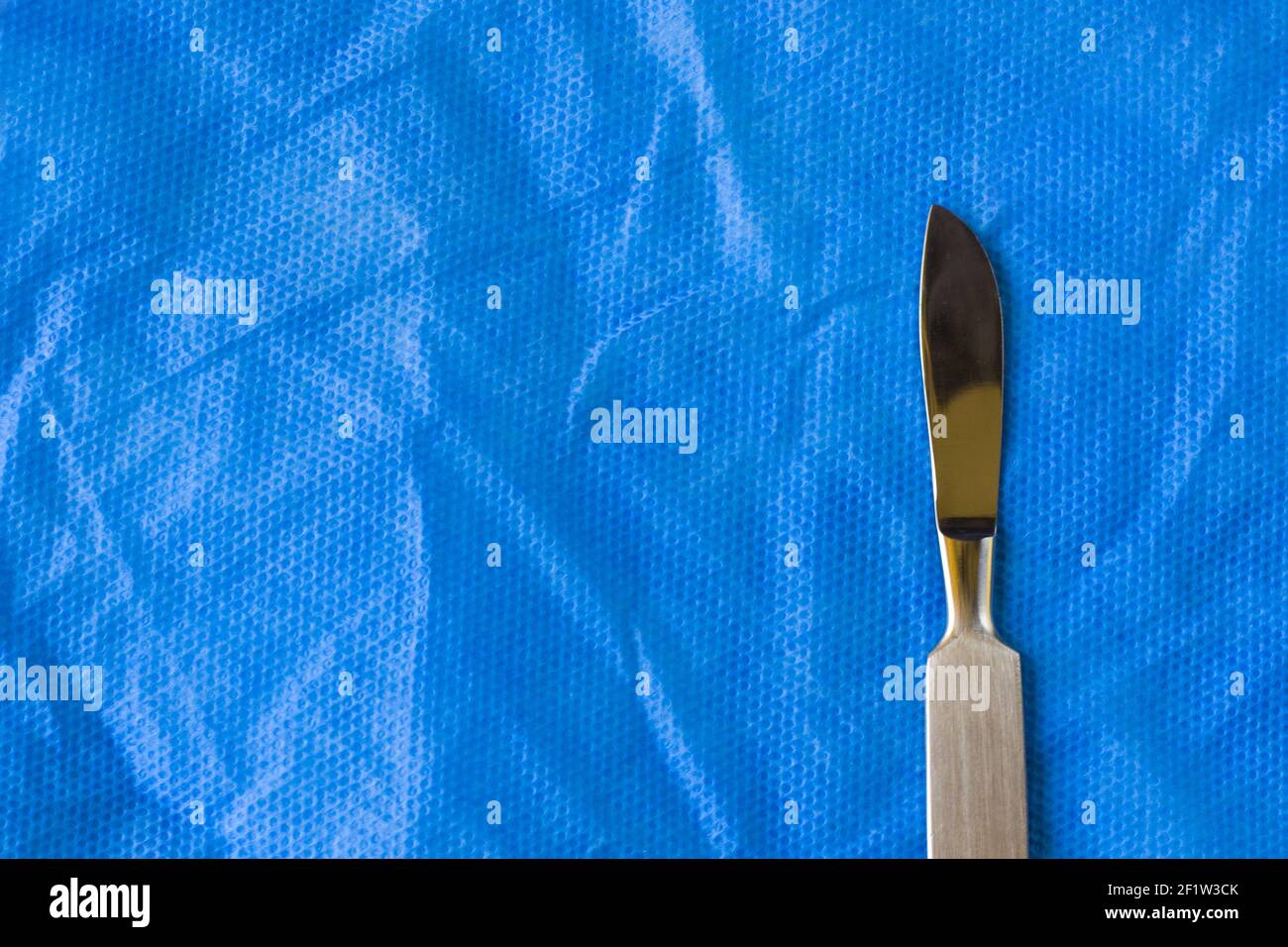 A top view of a scalpel on a blue surface in the hospital Stock Photo ...