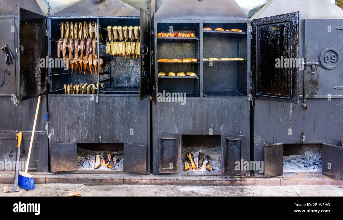 A view of fish being smoked in large metal smokers Stock Photo - Alamy