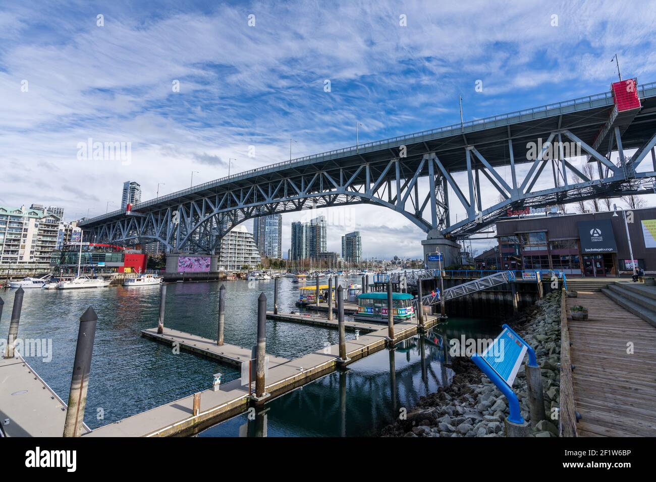 Granville Island Ferry Dock. Granville Bridge and Vancouver buildings ...