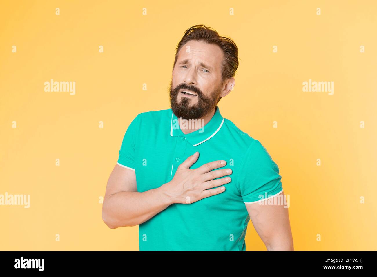 Cardiology disease. Man mature sportsman painful face feel badly heart ...