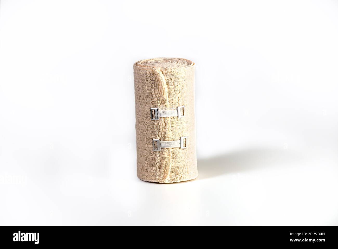 Woven elastic medical bandage rolled into roll and fixation clips ...