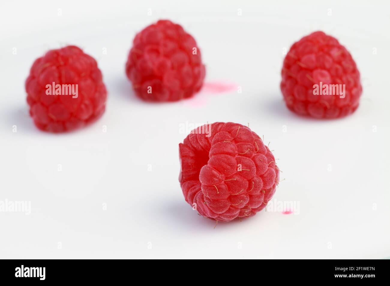 Close up on raspberries isolated on white background Stock Photo - Alamy