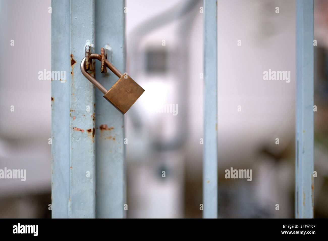 detail of a padlock closing two leaves of a metal door Stock Photo - Alamy