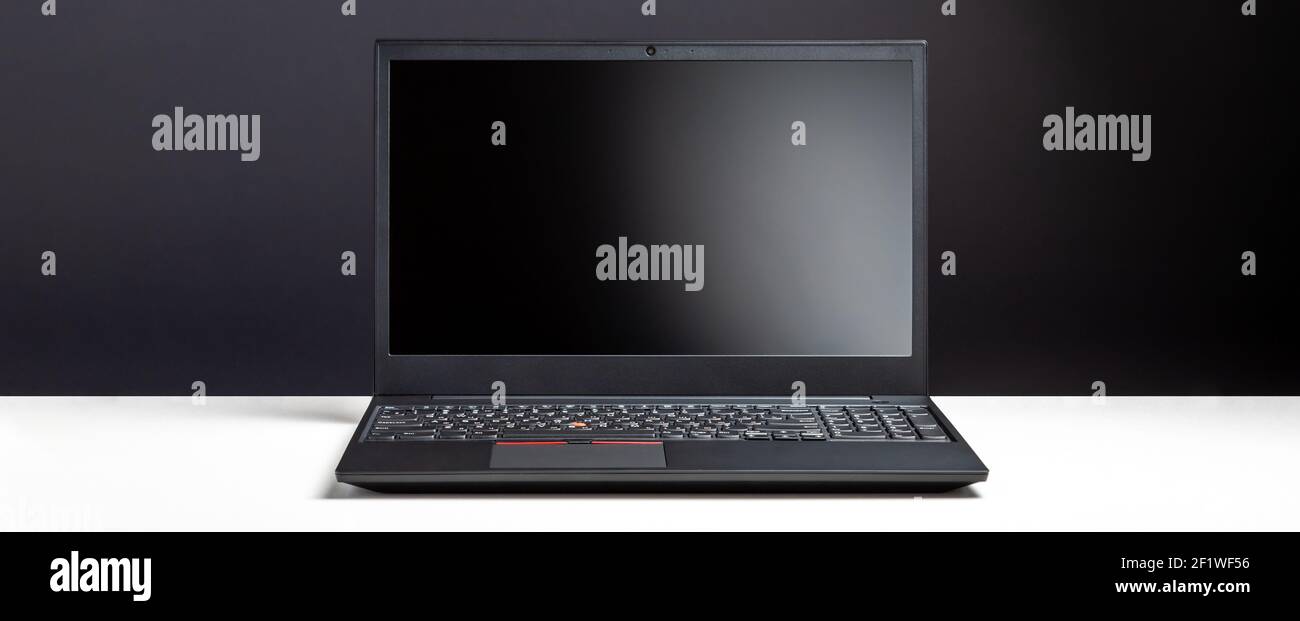 Empty open laptop with mockup on white desk table with black screen ...