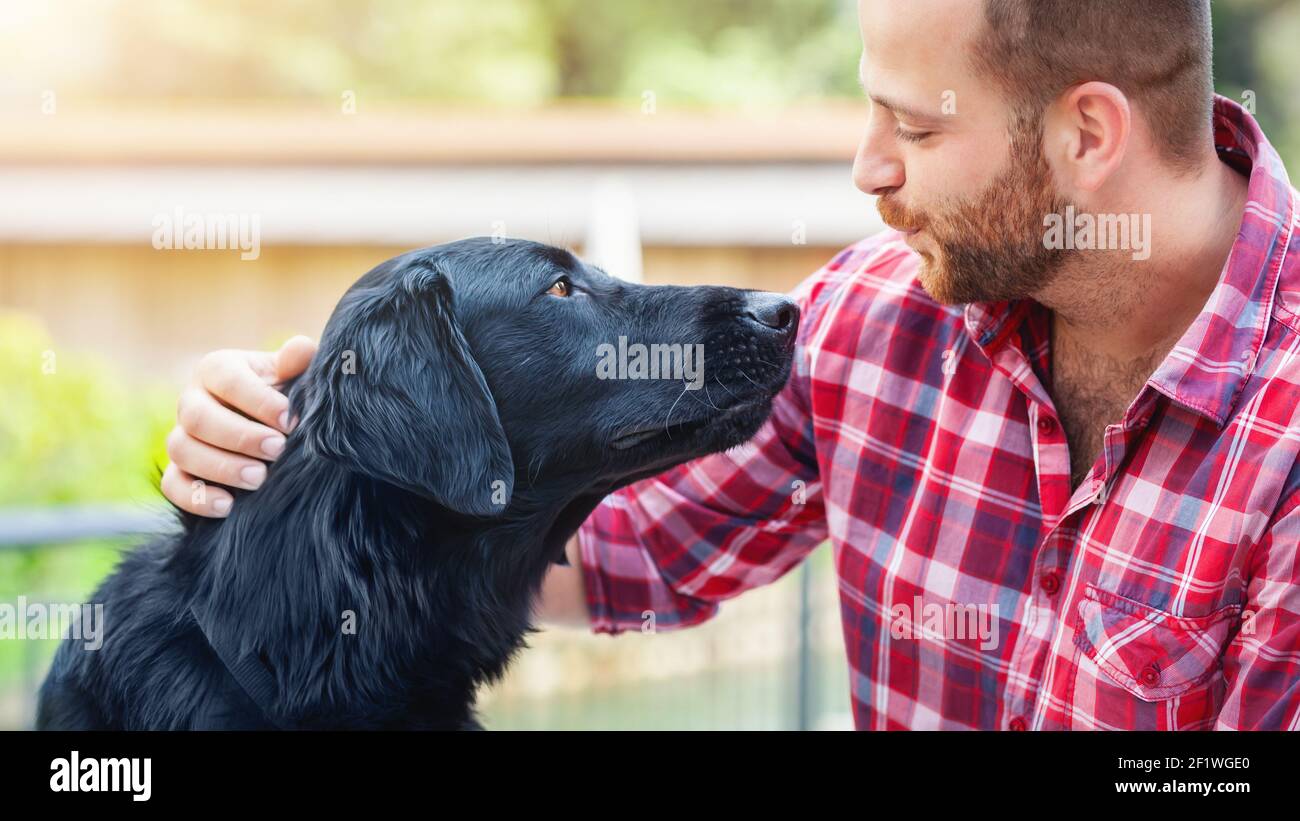 Man with black labrador hi-res stock photography and images - Alamy