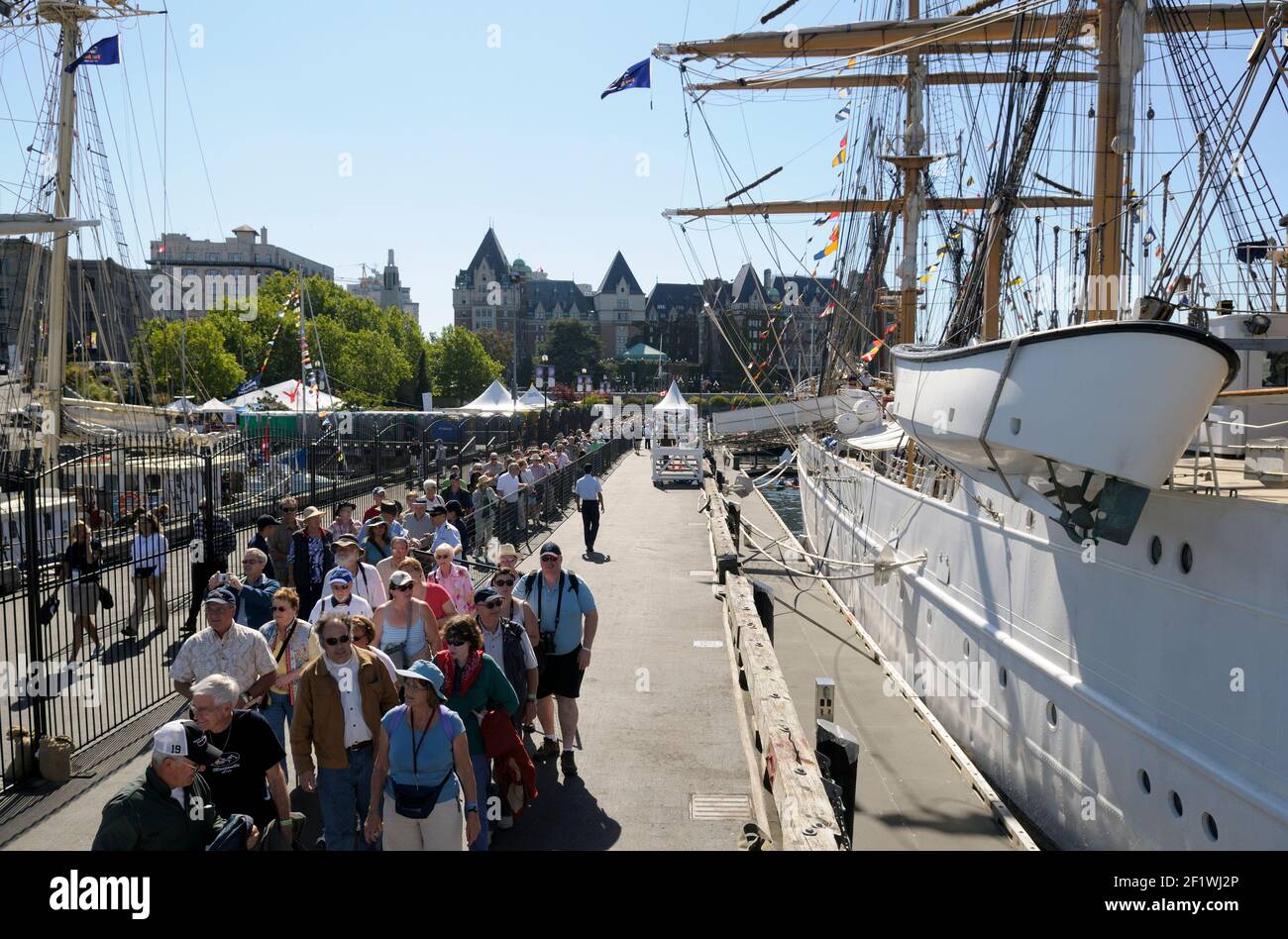 A crowd of people at Tall Ships Victoria waiting to board the USCG ...