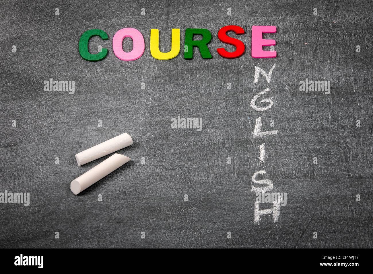 English Course concept. Colored letters of the alphabet on a dark chalk ...