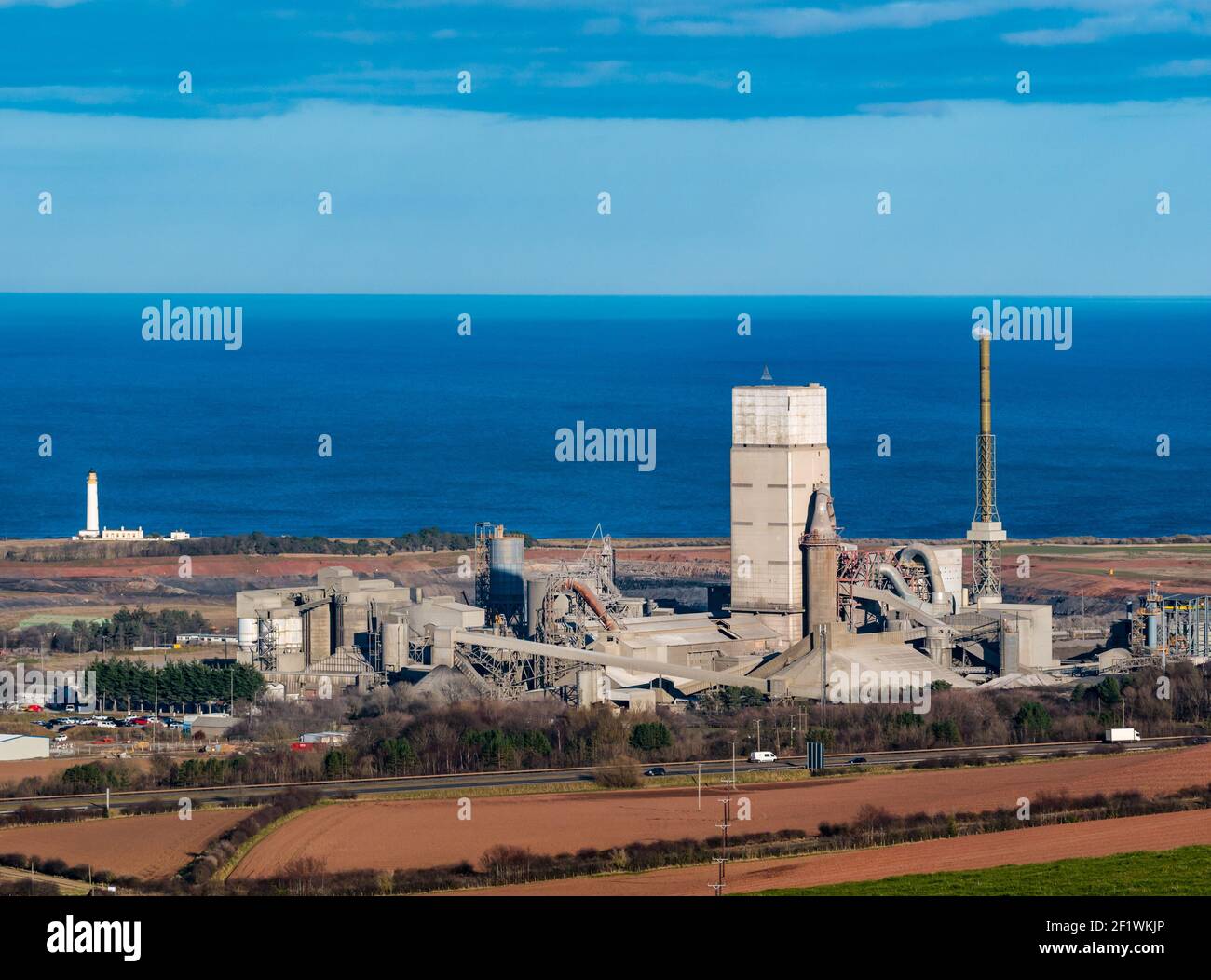 Industrial towers of Dunbar cement works and Barns Ness lighthouse on ...