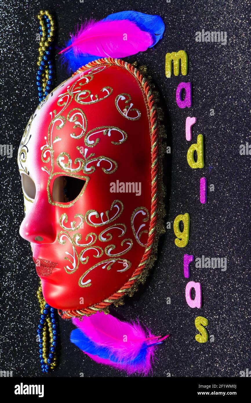 Mardi Gras Full Mask With Feathers And Bead Strings Stock Photo - Alamy