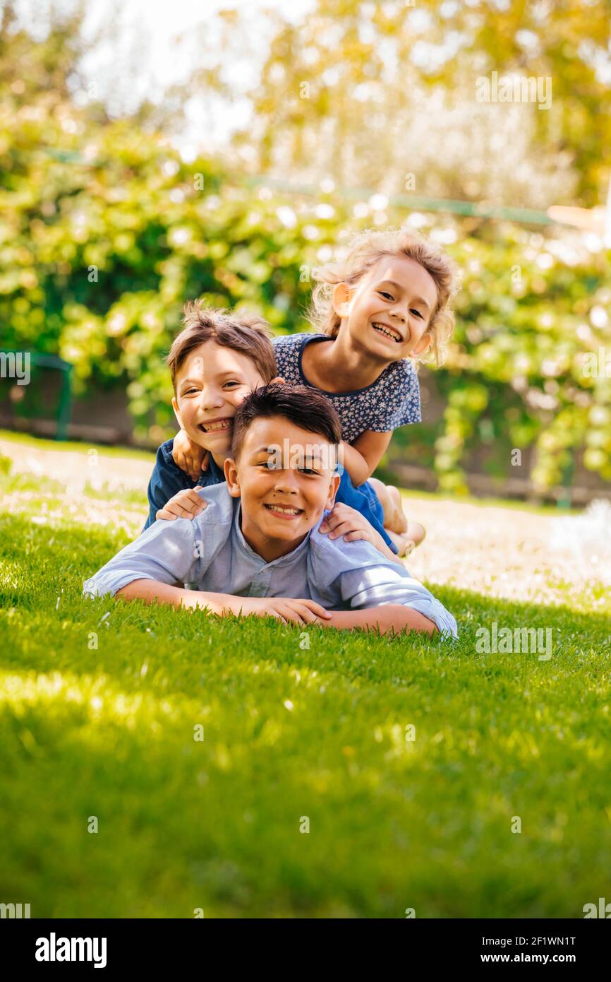 Portrait of three little children as a tower Stock Photo - Alamy