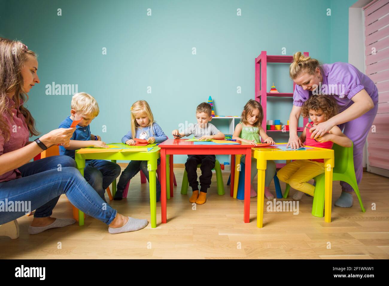 educator and cute preschoolers are making colorful postcards Stock ...