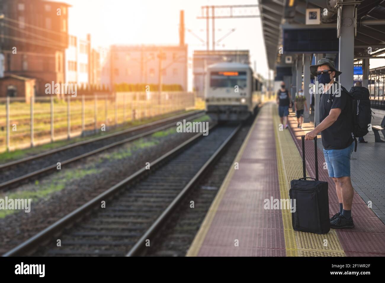 Man with a mask waiting for a train during Covid19 pandemic Stock Photo ...