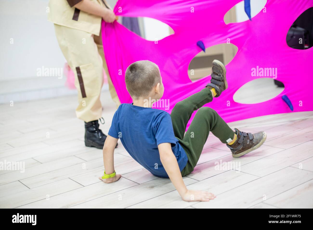 The children are crawling through holes in the fabric Stock Photo - Alamy