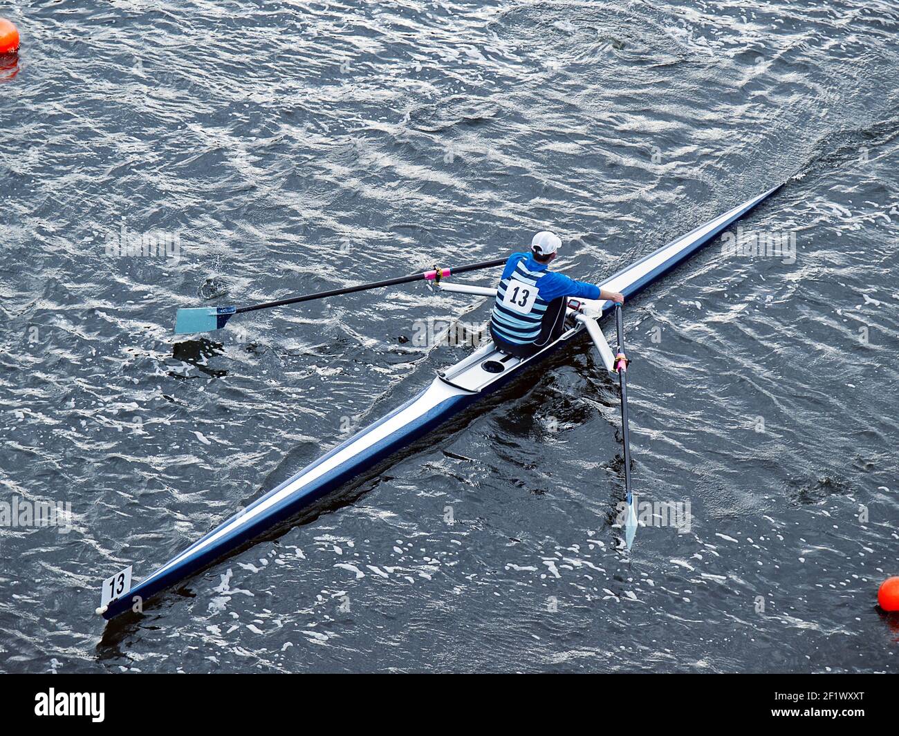 Man rowing in boat on water Stock Photo - Alamy