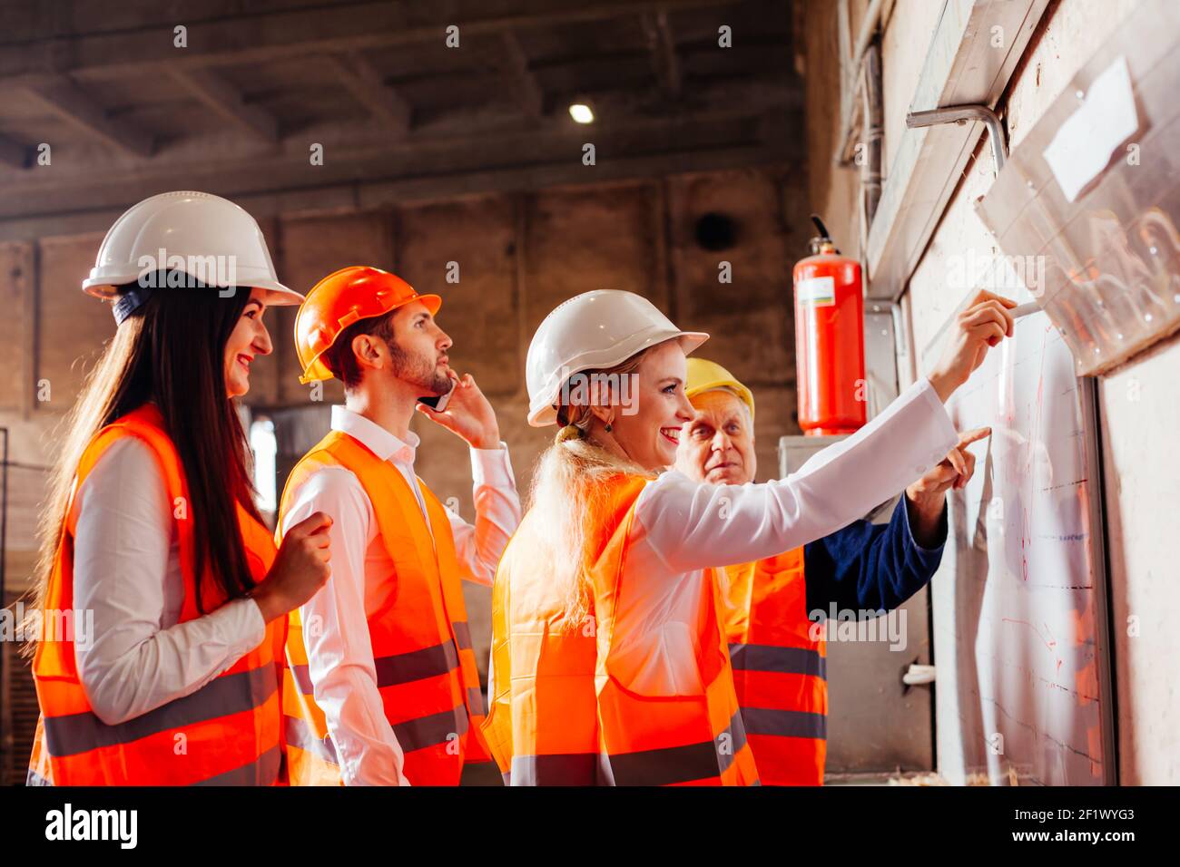 The workers draw up a plan of work at the plant Stock Photo - Alamy