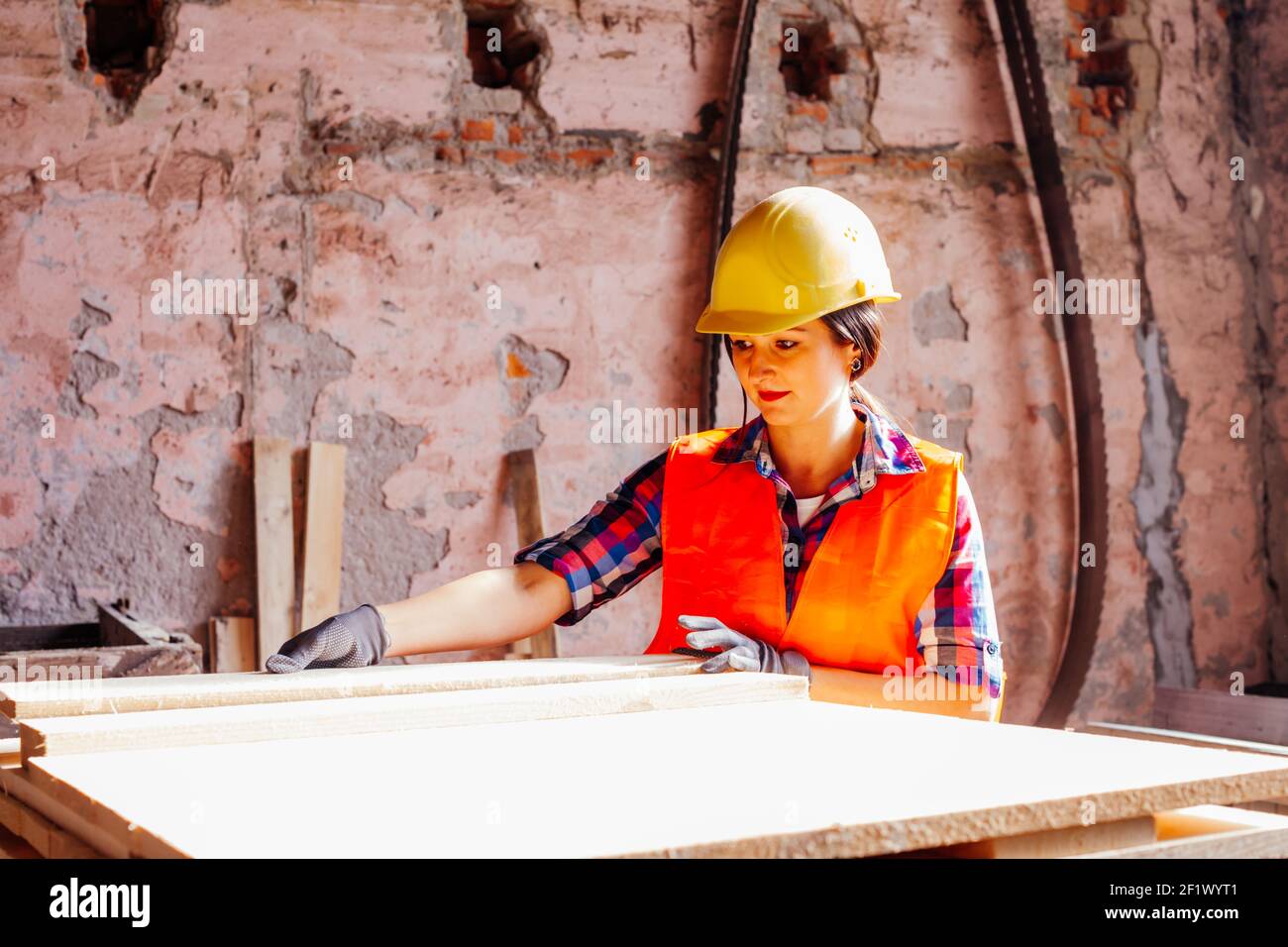Woman worker at the plant, wearing yellow hard Stock Photo - Alamy