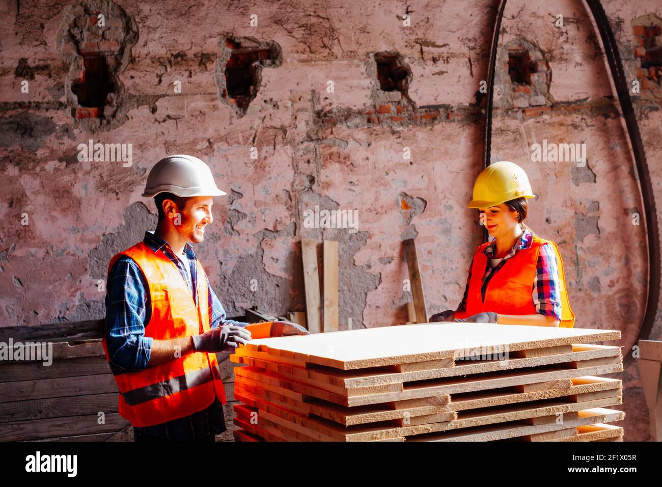 Pair of attractive workers indoors woodworking workflore Stock Photo ...