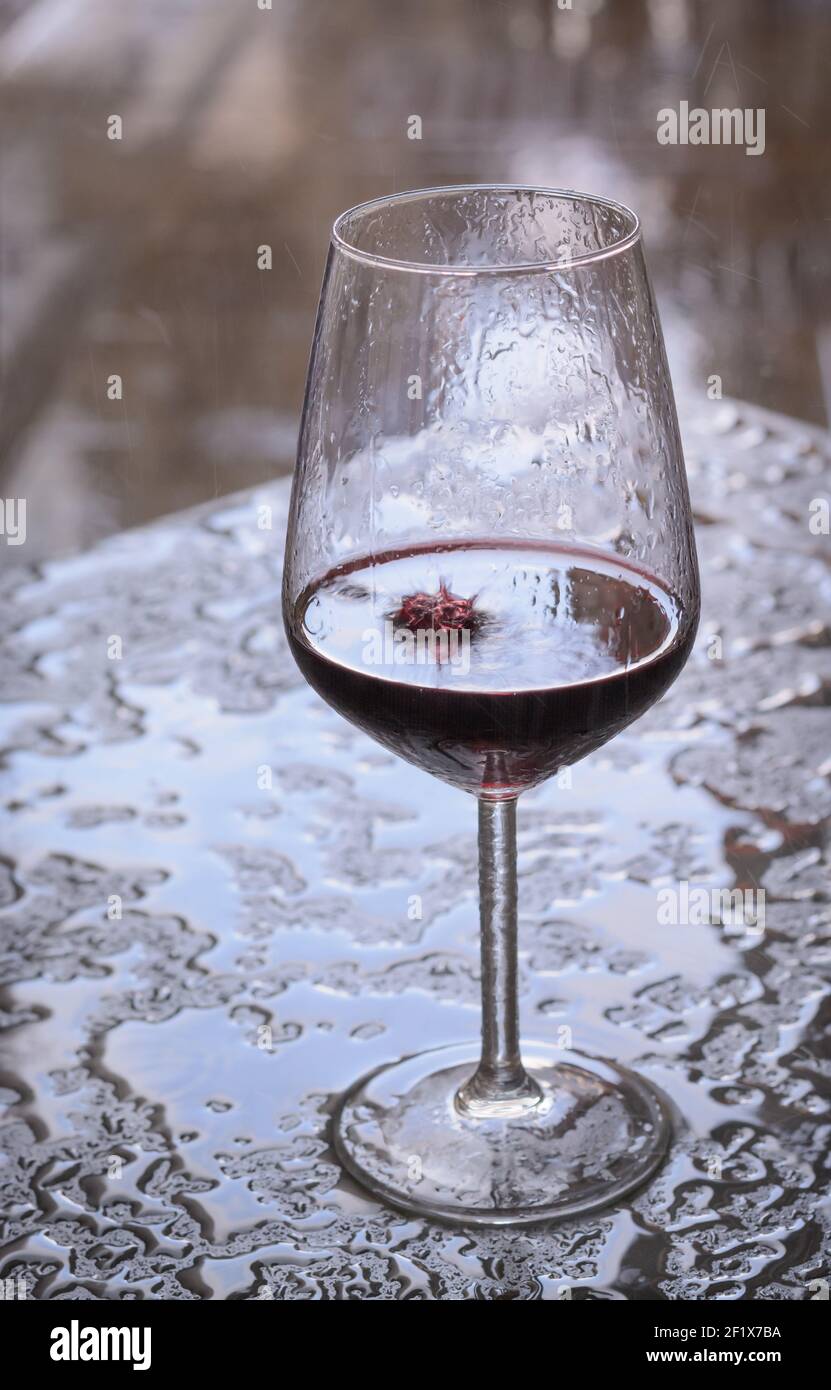 Glass of red wine with rain drops Stock Photo - Alamy