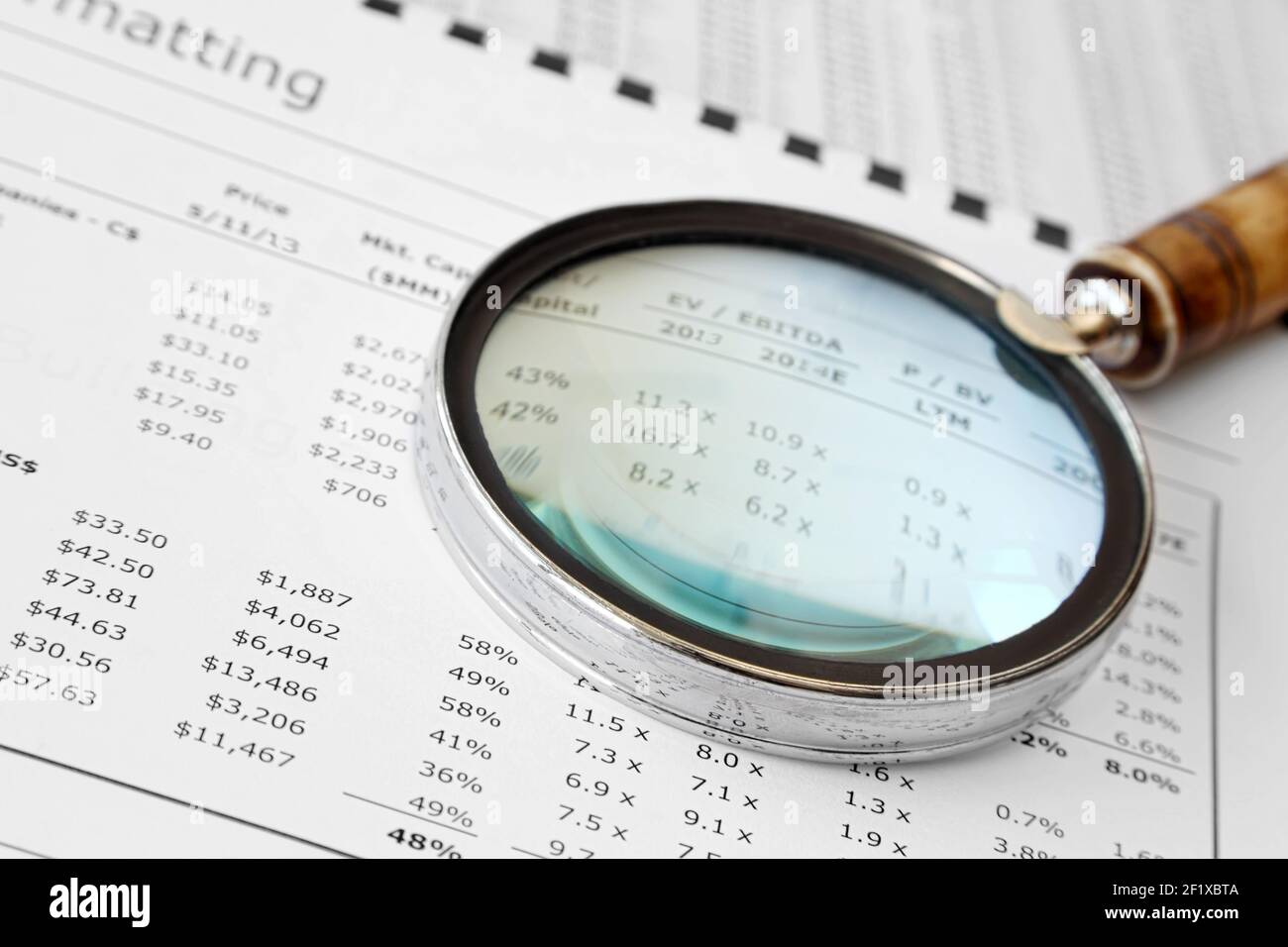 Magnifying Glass Over Financial Document Stock Photo - Alamy