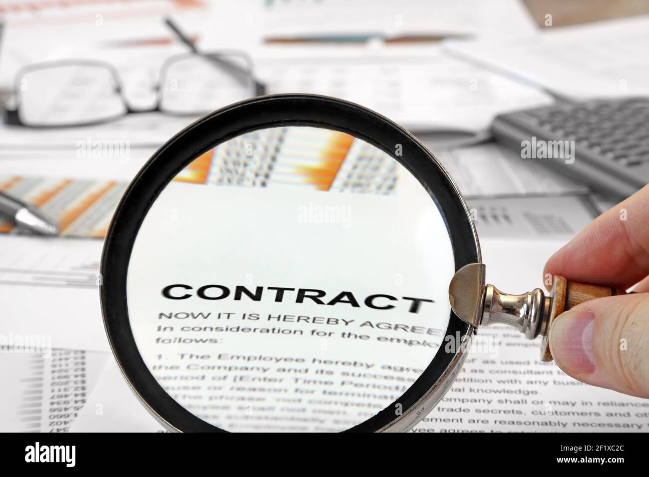 Magnifying Glass Over Contract Papers Stock Photo - Alamy