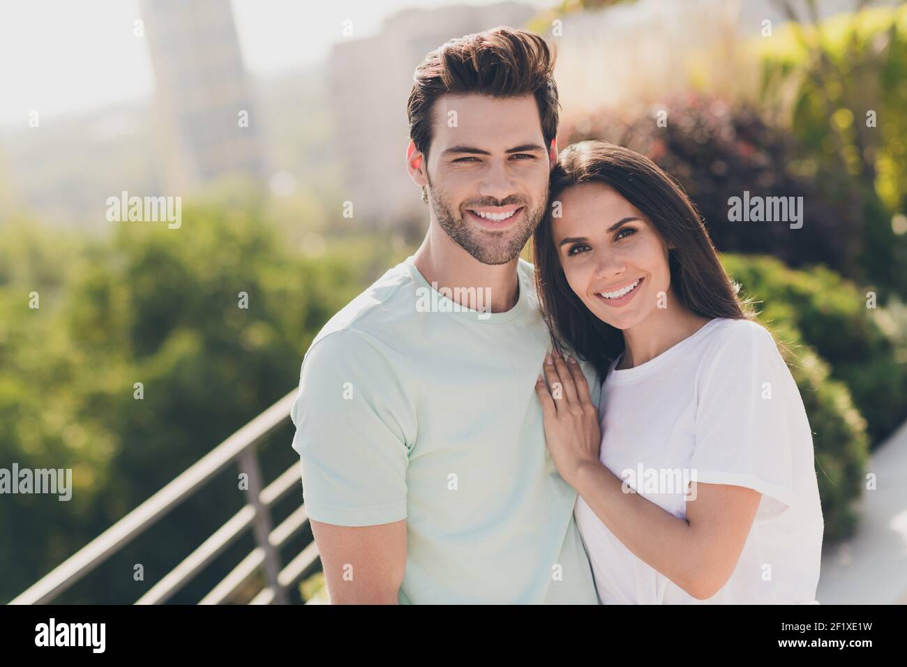 Photo of cheerful beautiful couple woman guy together hand chest cuddle ...
