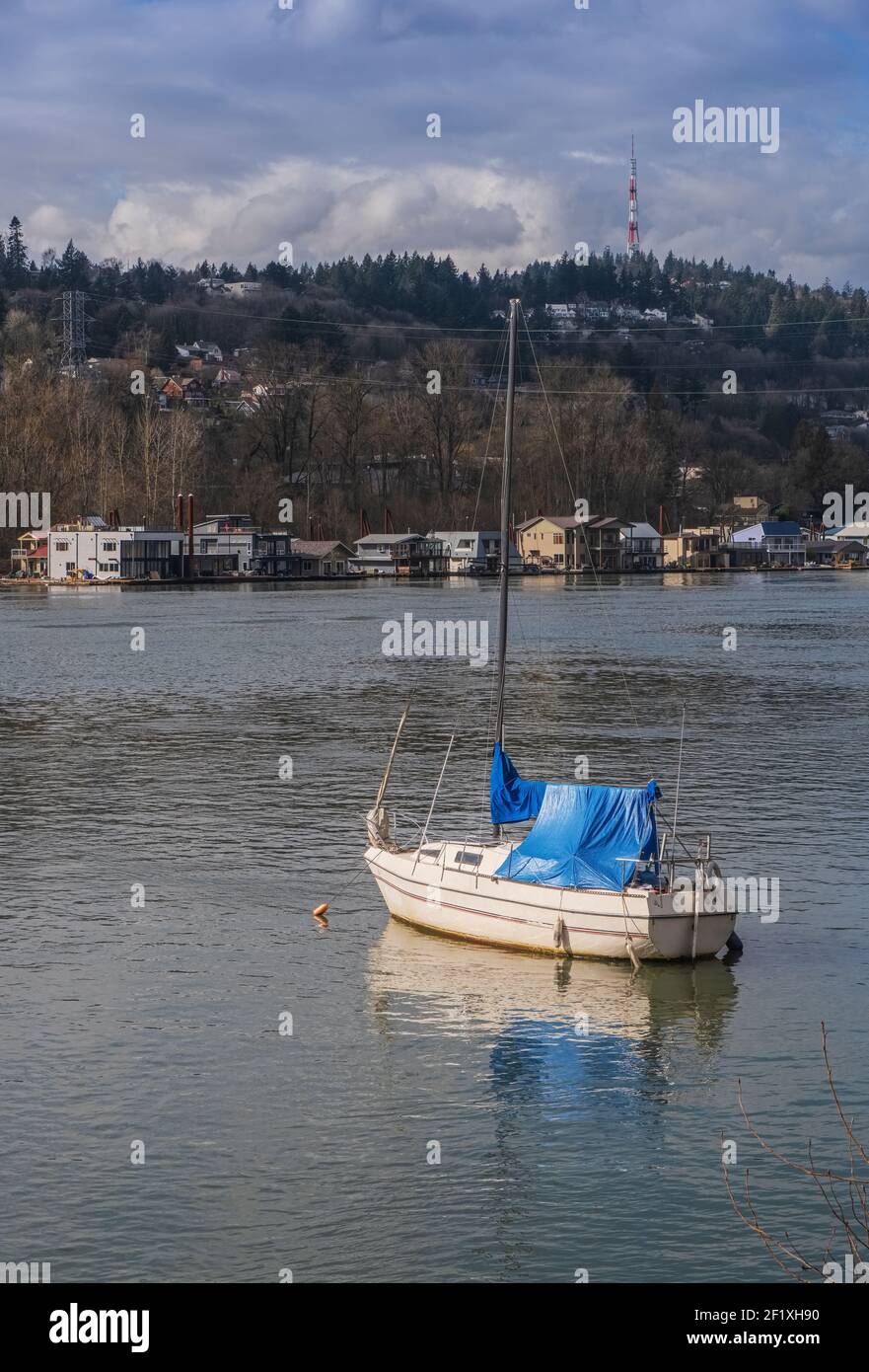Lone sailboat anchored in a river Portland Oregon Stock Photo - Alamy