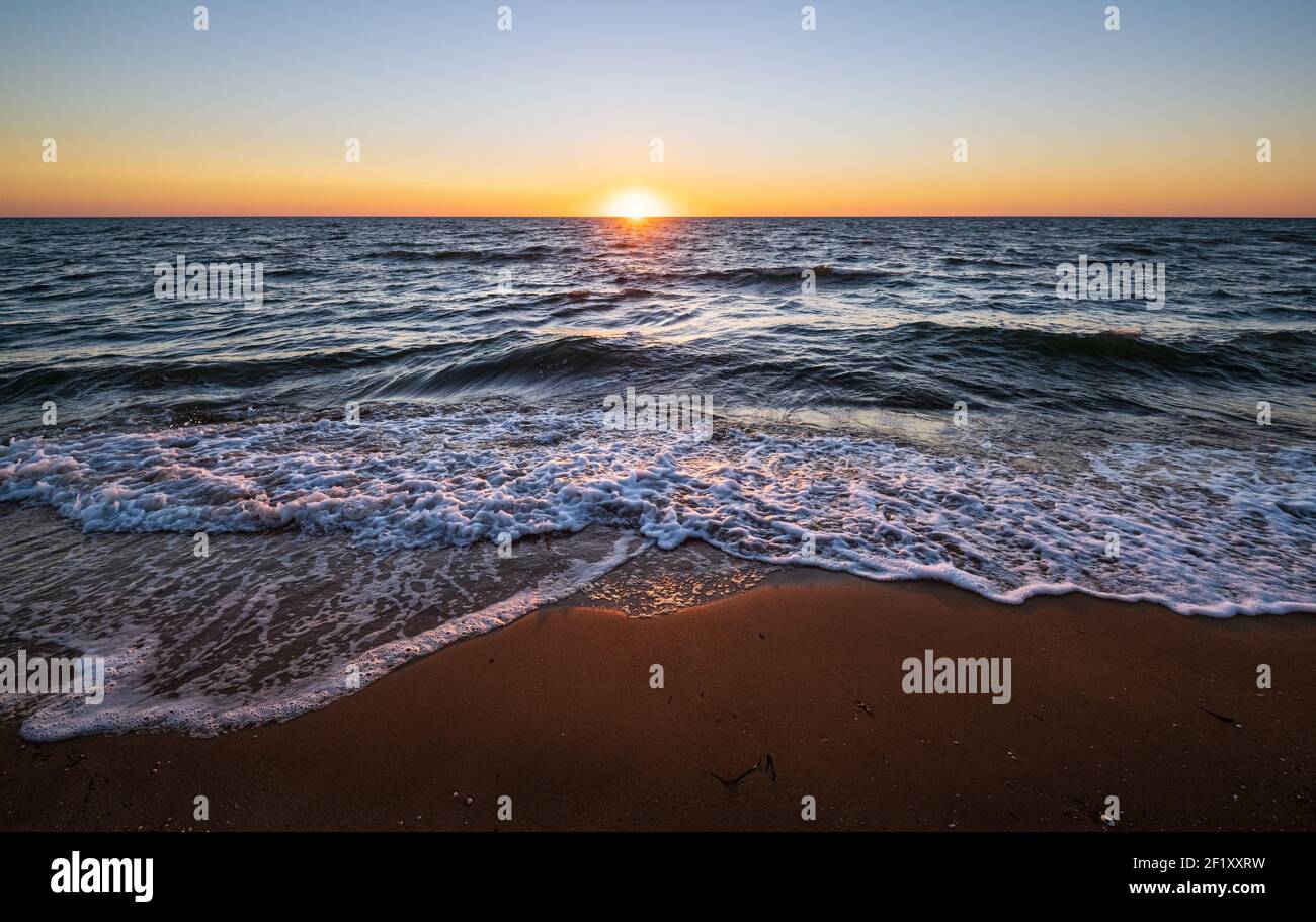 Colorful sea beach sunrise Stock Photo - Alamy