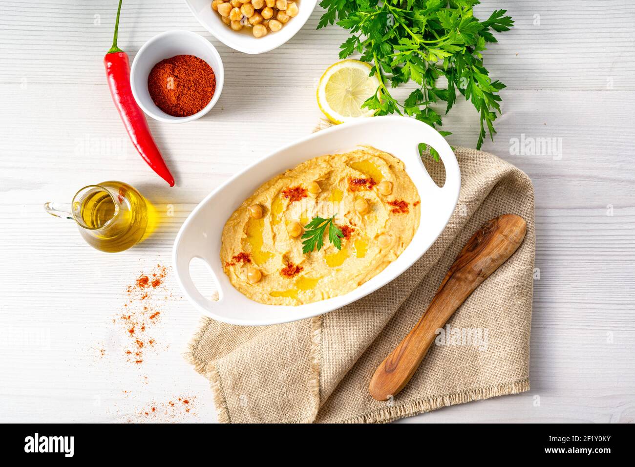 Hummus paste with lemon and chilli on white background Stock Photo - Alamy