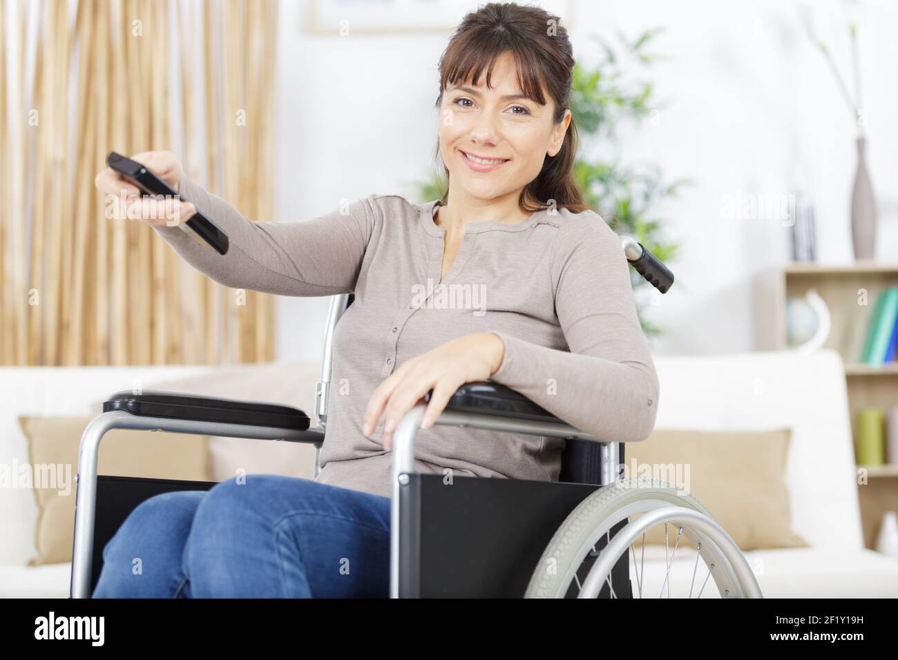 disabled woman in wheelchair watching movies at home Stock Photo - Alamy