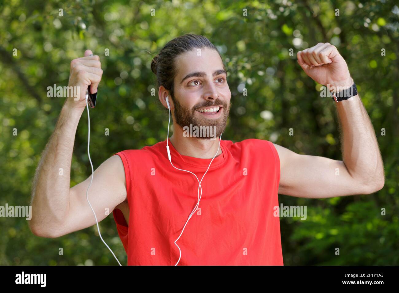 happy athlete raising his hands up Stock Photo - Alamy