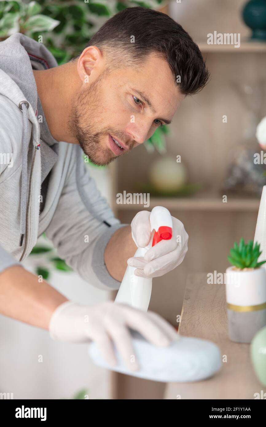 Man cleaning furniture spray hi-res stock photography and images - Alamy