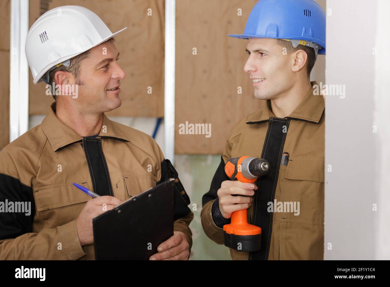 Two young builders holding hi-res stock photography and images - Alamy