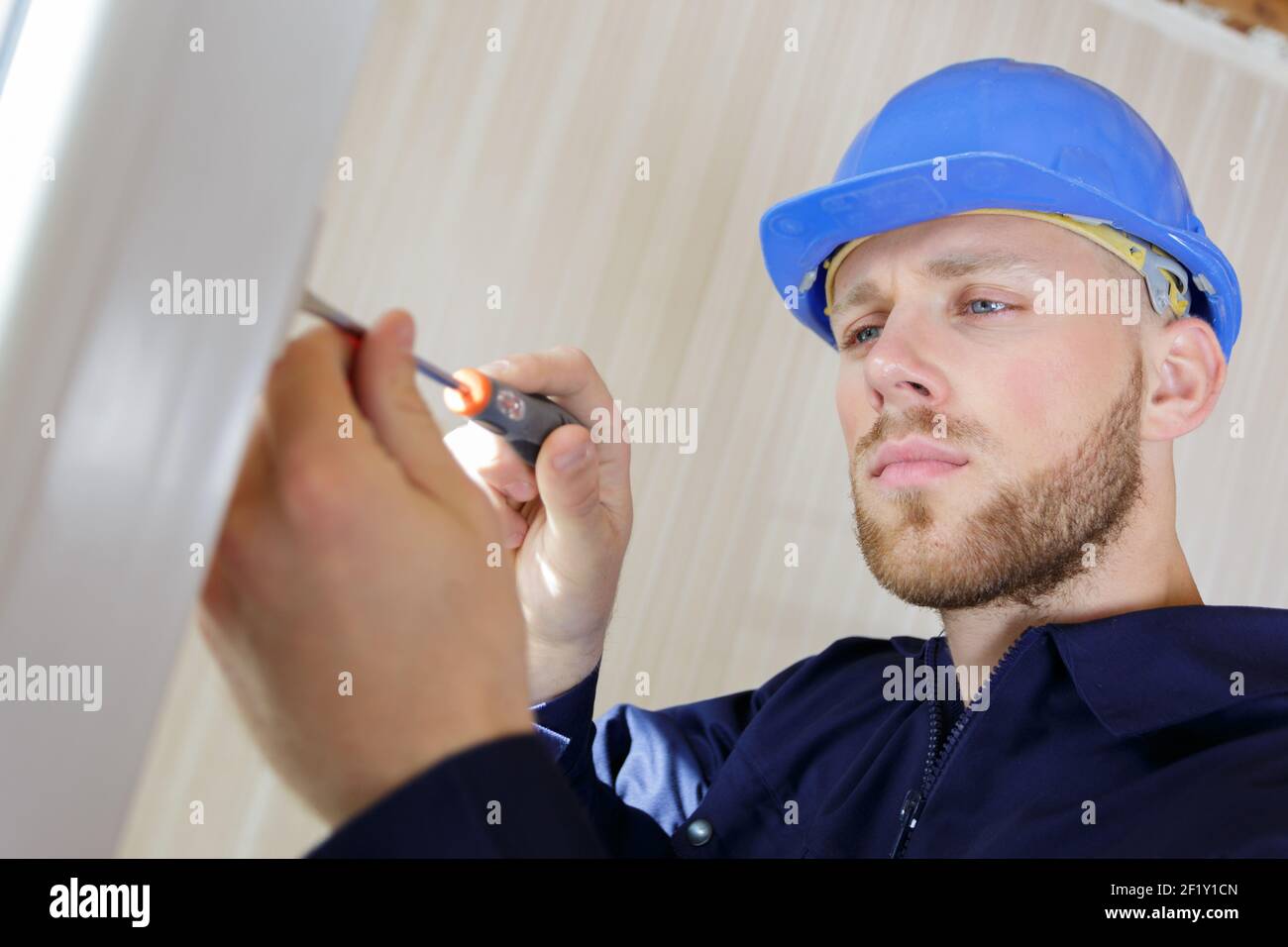 professional handyman installing window at home Stock Photo - Alamy
