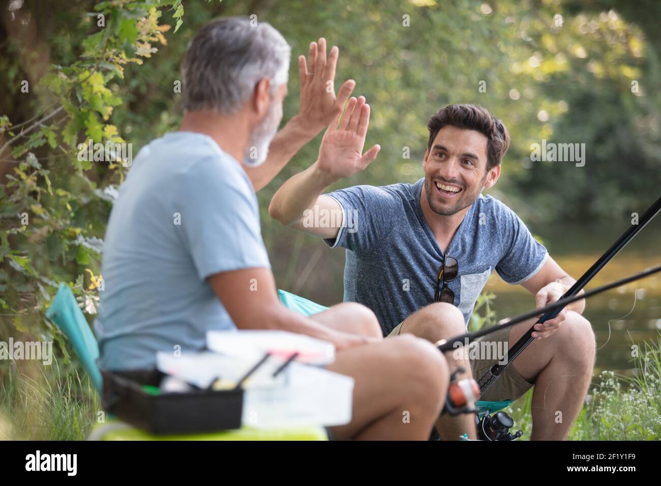 senior friends giving a high five Stock Photo - Alamy