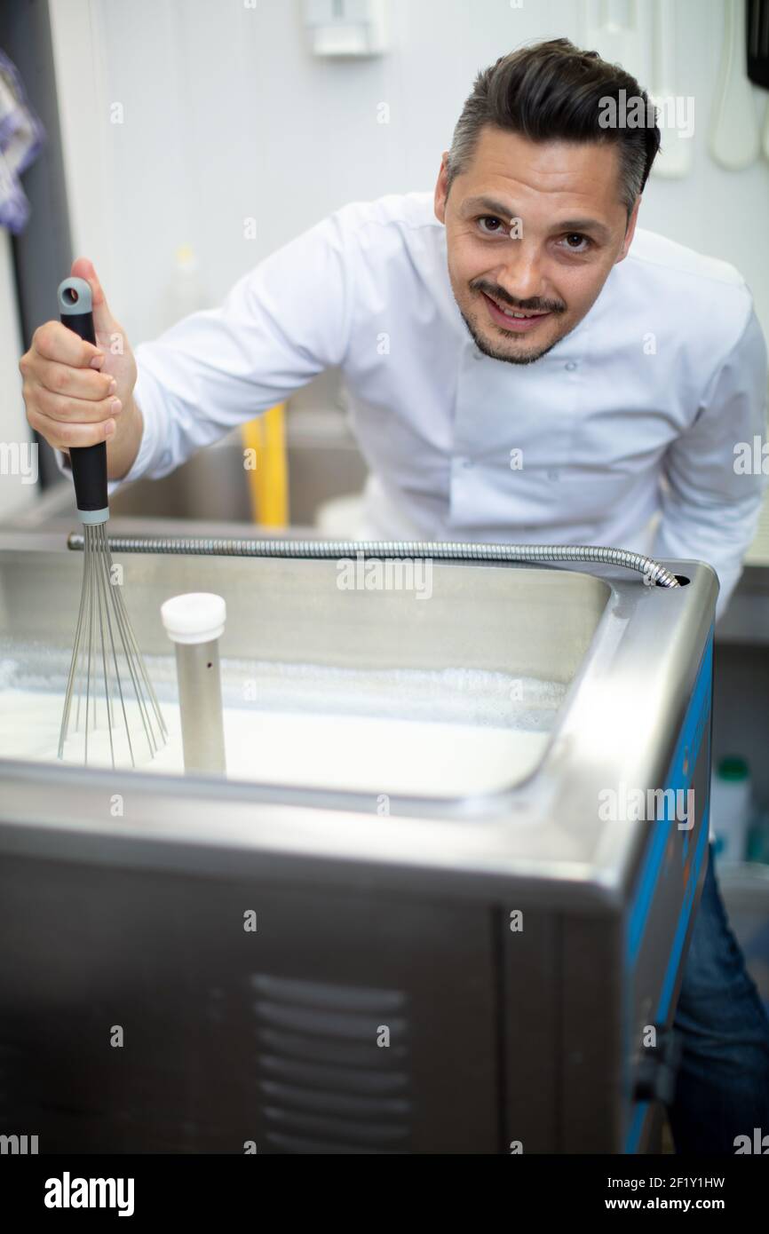 portrait of a chef cook mixing ice cream production Stock Photo - Alamy