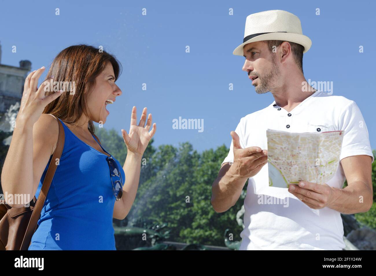 angry couple of tourists exploring new city together Stock Photo - Alamy