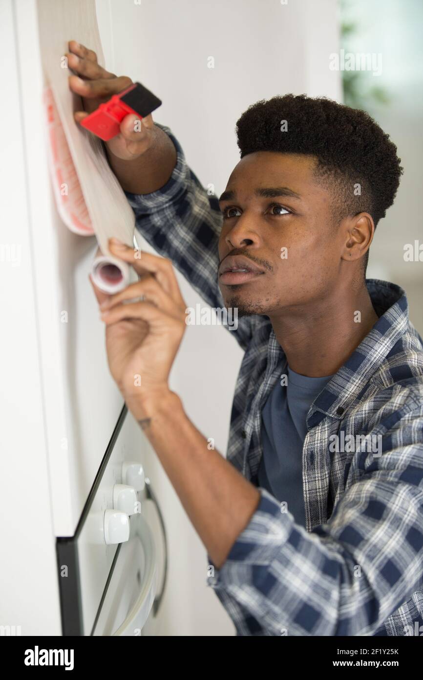 man revamping his kitchen cupboard Stock Photo - Alamy