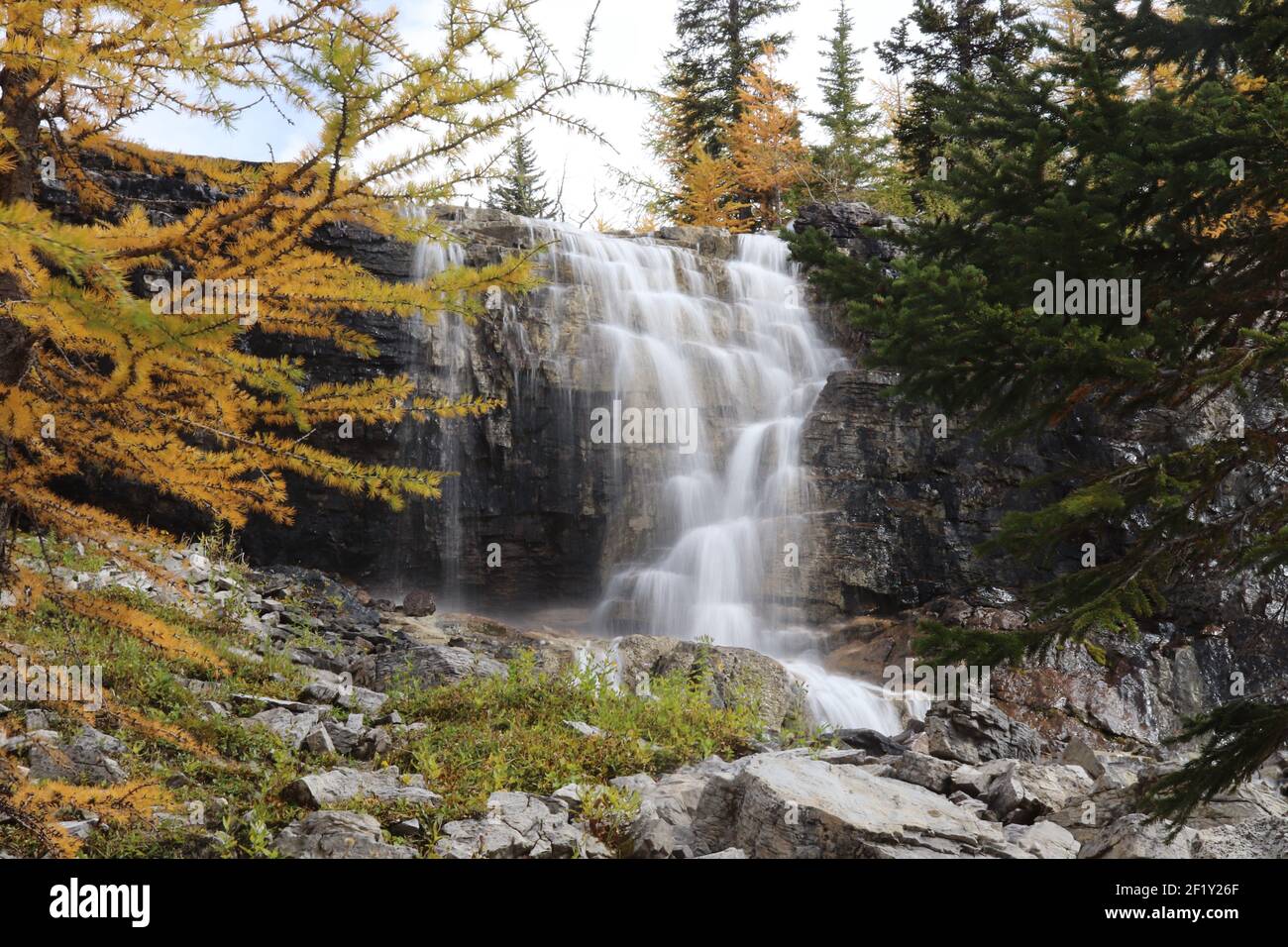 Talon Waterfalls in Autum, orange larch and green spruce trees, rocks ...