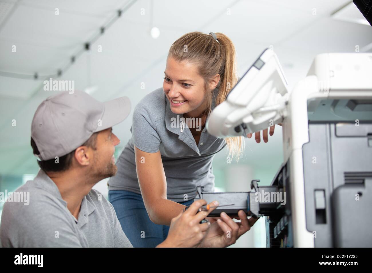 happy workers fixing a printer Stock Photo - Alamy